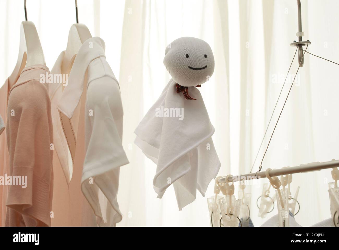 Indoor drying laundry and a paper doll Stock Photo - Alamy