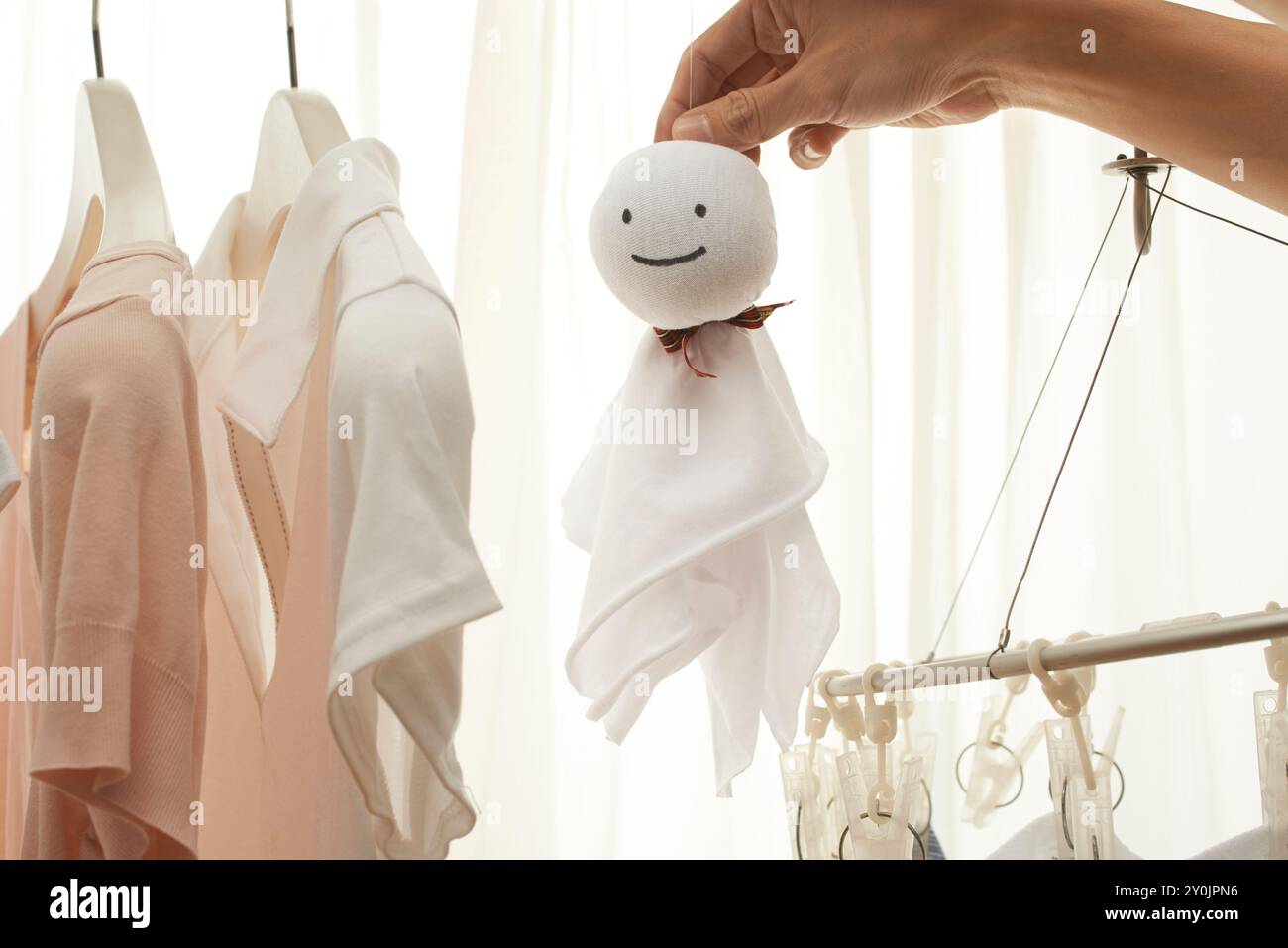 Indoor drying laundry and a paper doll Stock Photo - Alamy