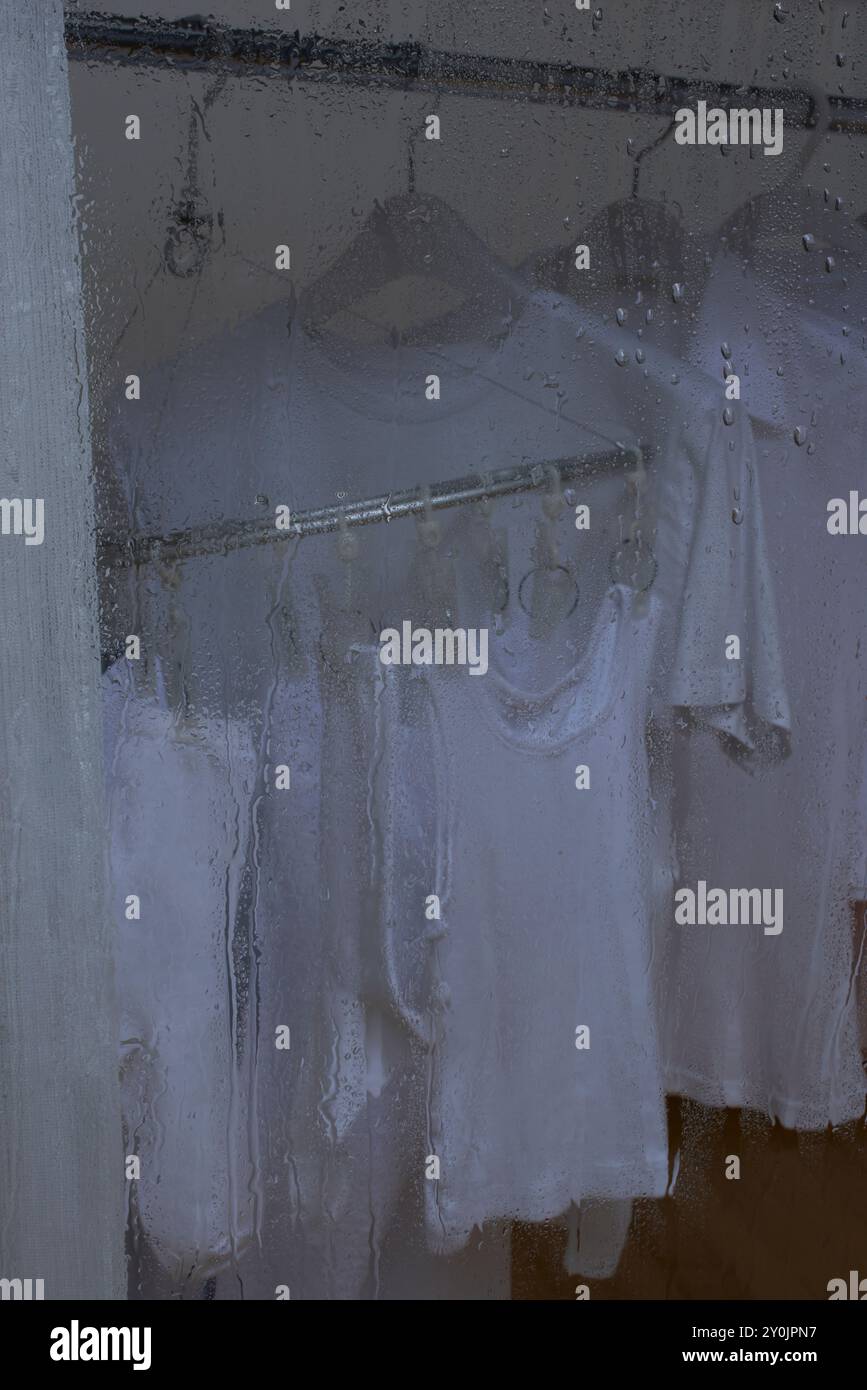 Indoor drying laundry looking through windows Stock Photo - Alamy