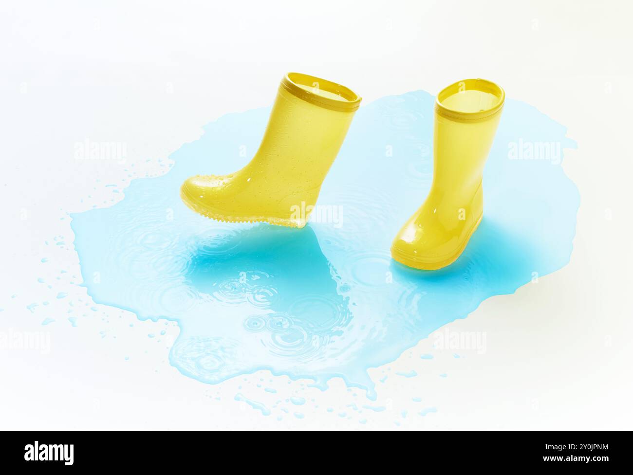 Light blue puddle and yellow boots Stock Photo - Alamy