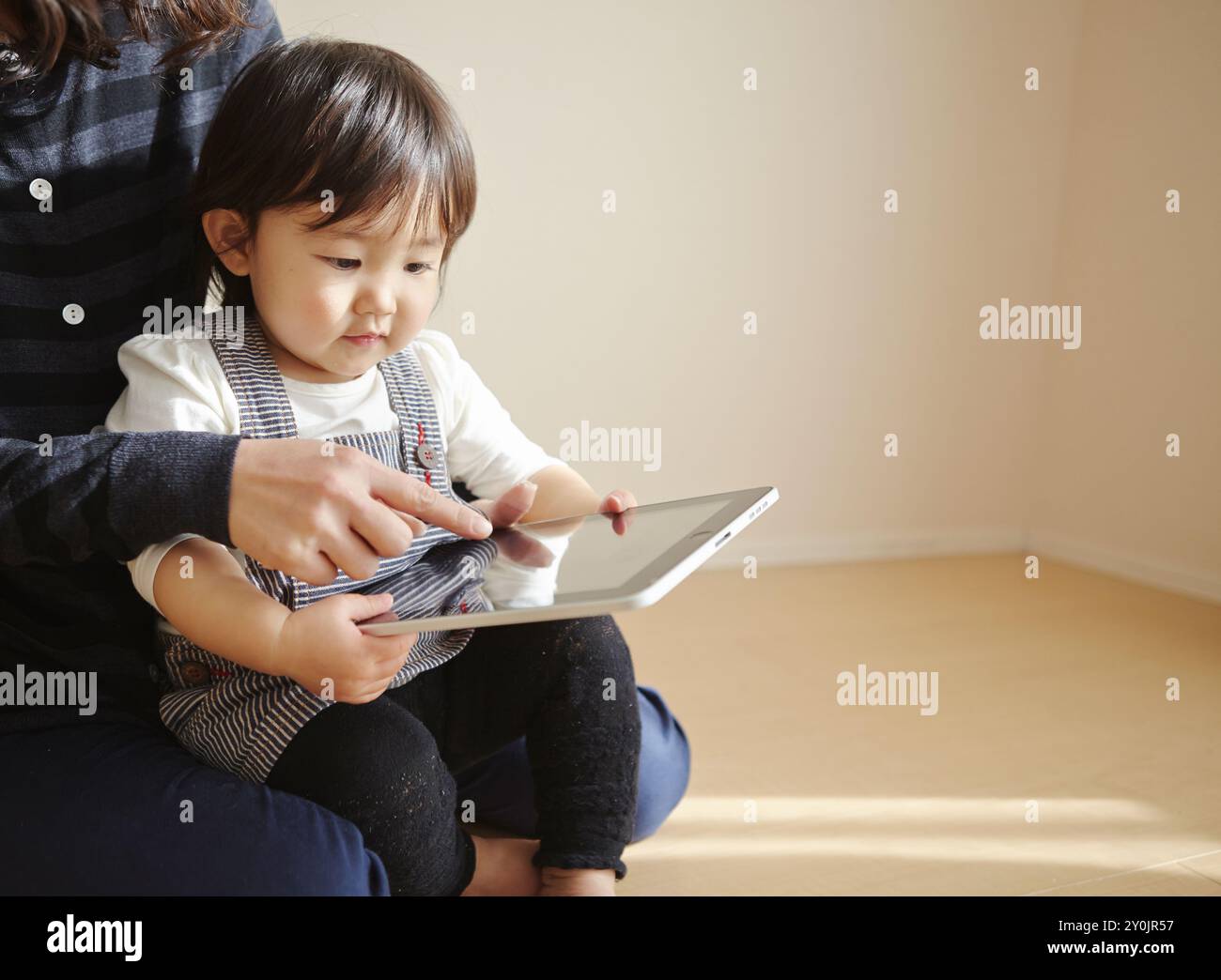 Girl looking at tablet Stock Photo - Alamy