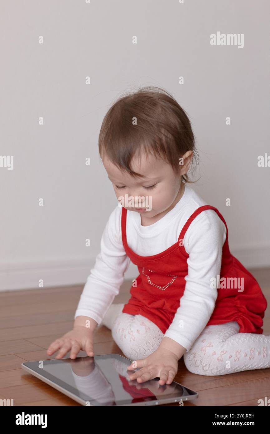 Girl playing with tablet on floor hi-res stock photography and images ...
