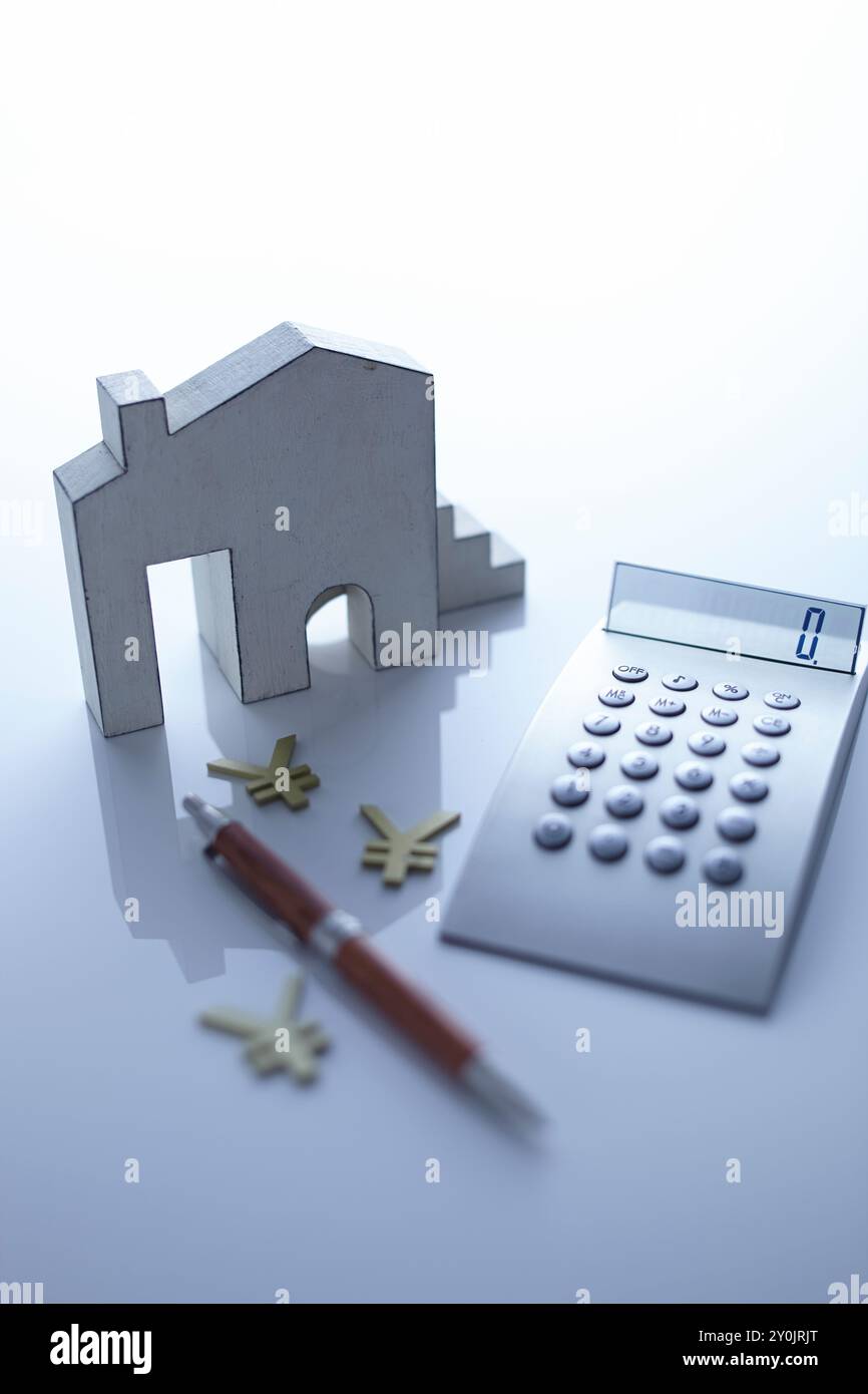 the commercial image of calculator and home Stock Photo - Alamy
