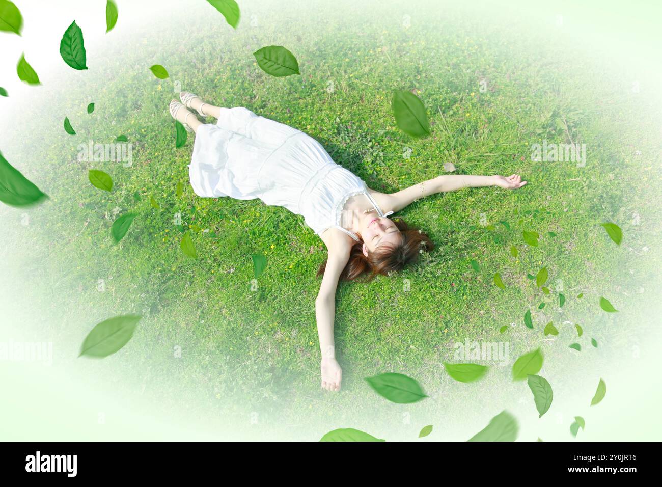 Leaves dancing in the wind and woman lying down on the green lawn Stock ...