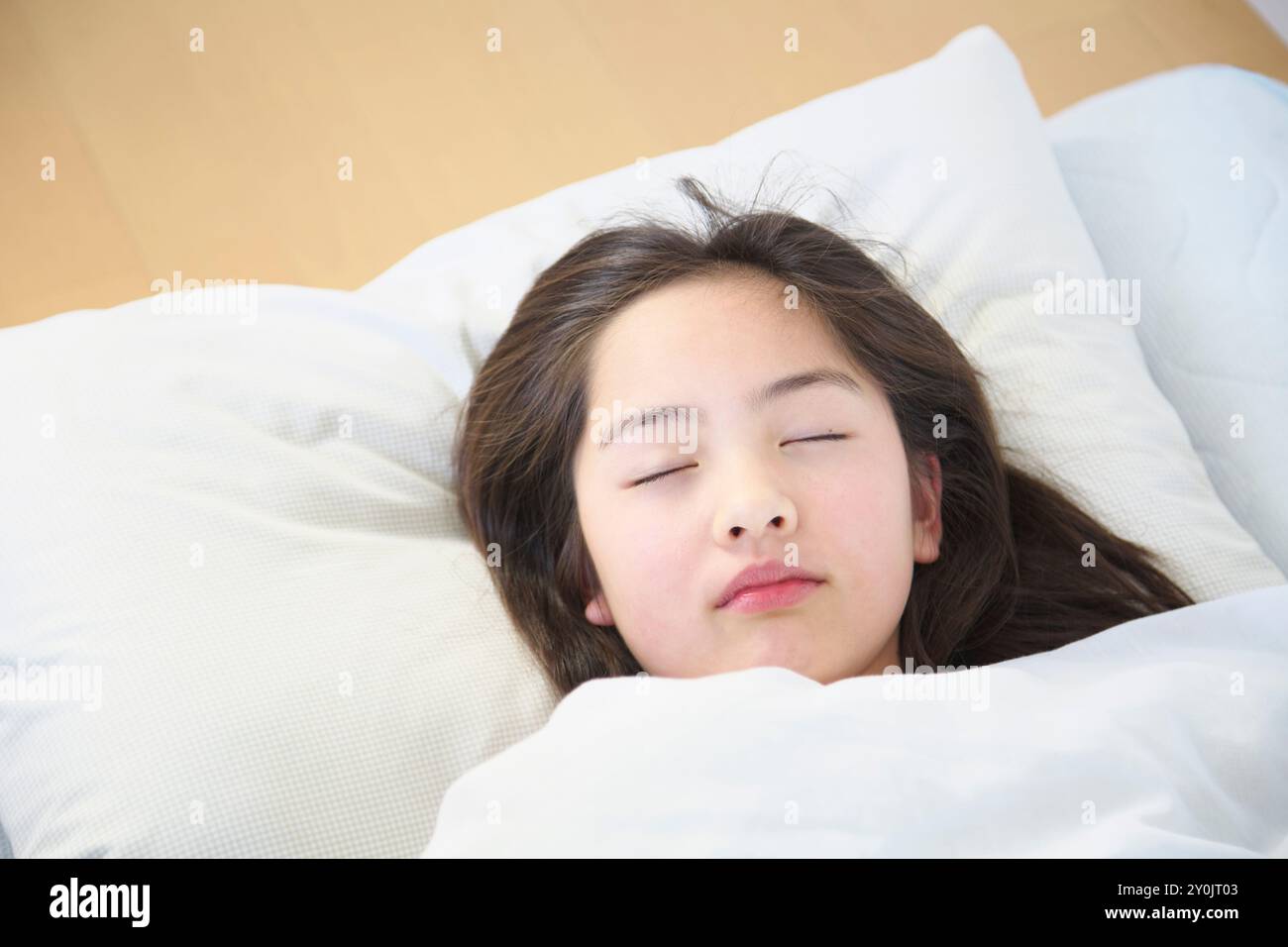 Girl sleeping on the futon Stock Photo - Alamy