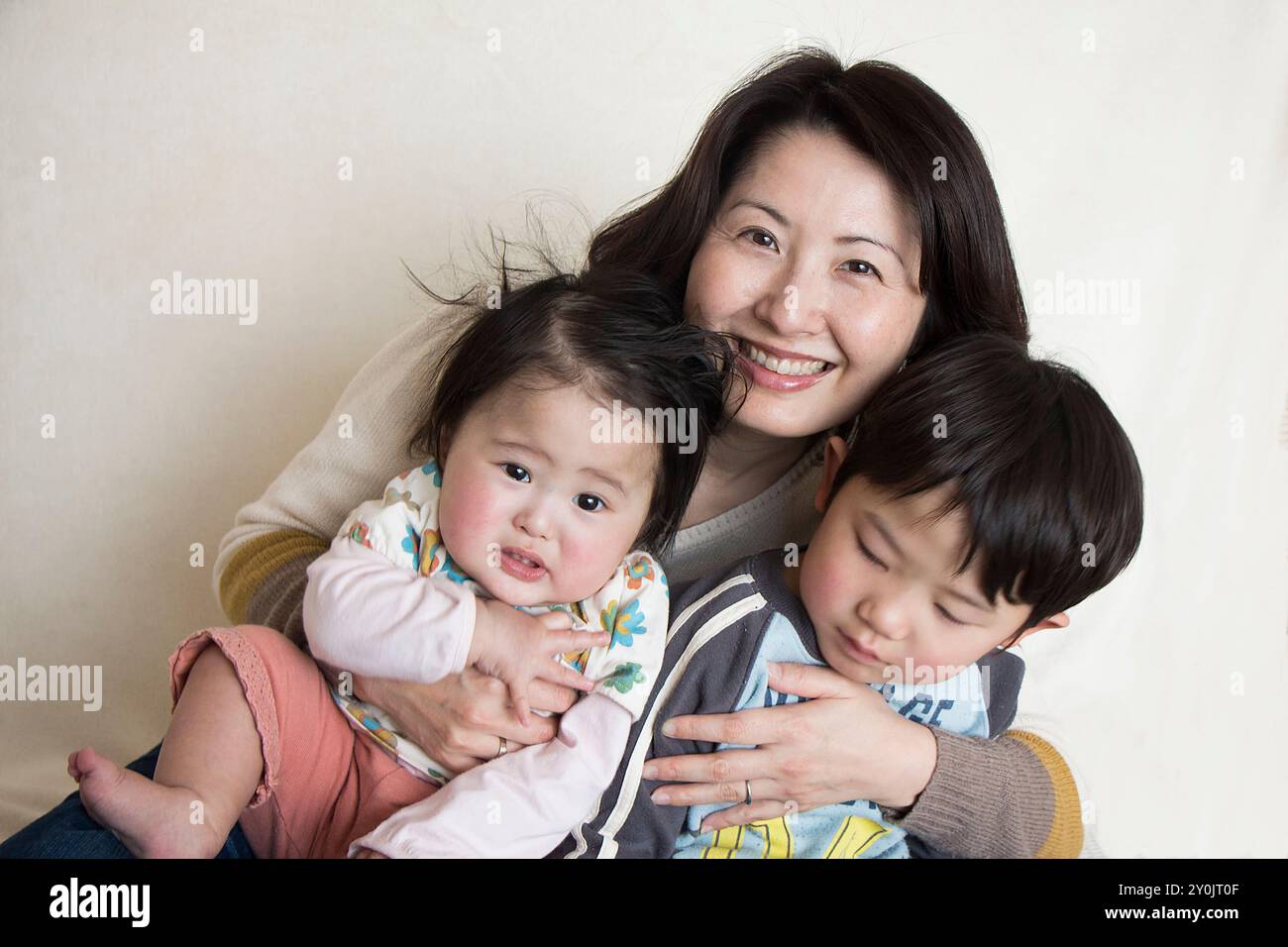 Mother holding her two children Stock Photo - Alamy