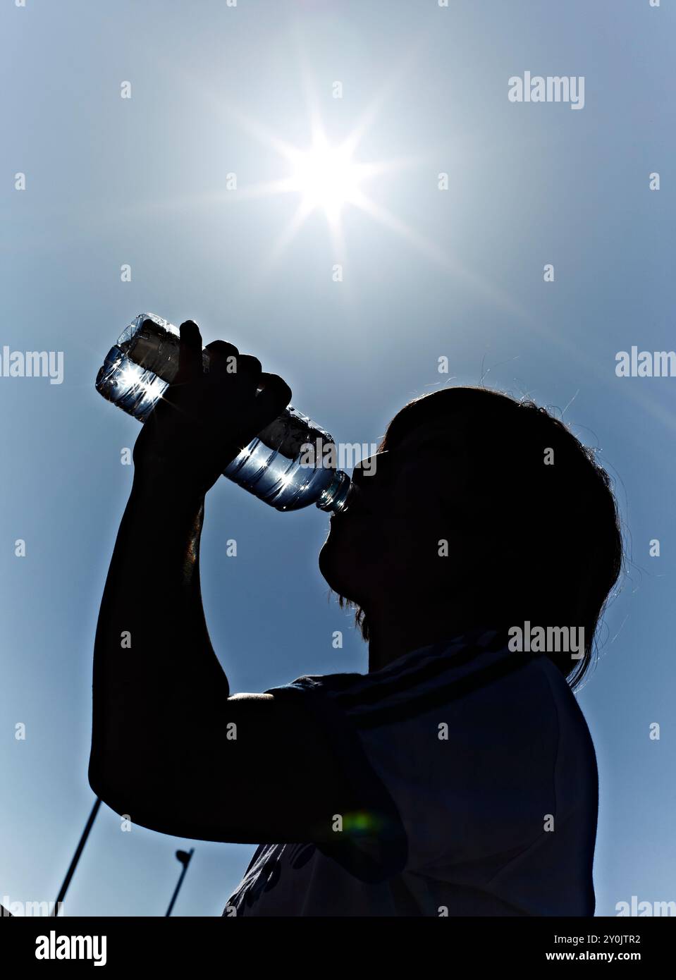 Image of sun and a man drinking bottled water Stock Photo - Alamy