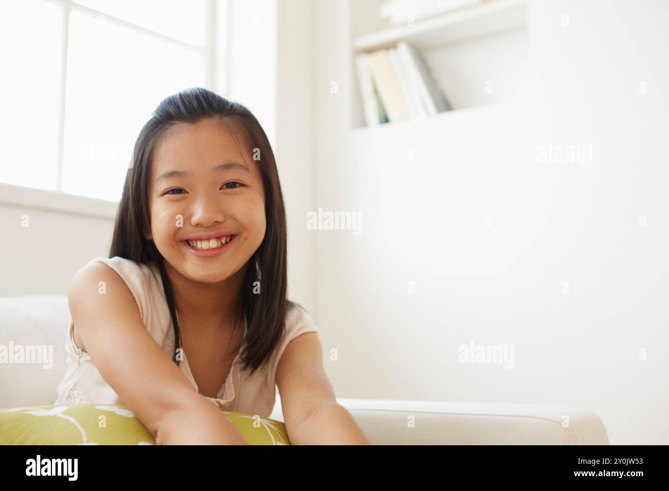 Girl sitting on a sofa Stock Photo - Alamy