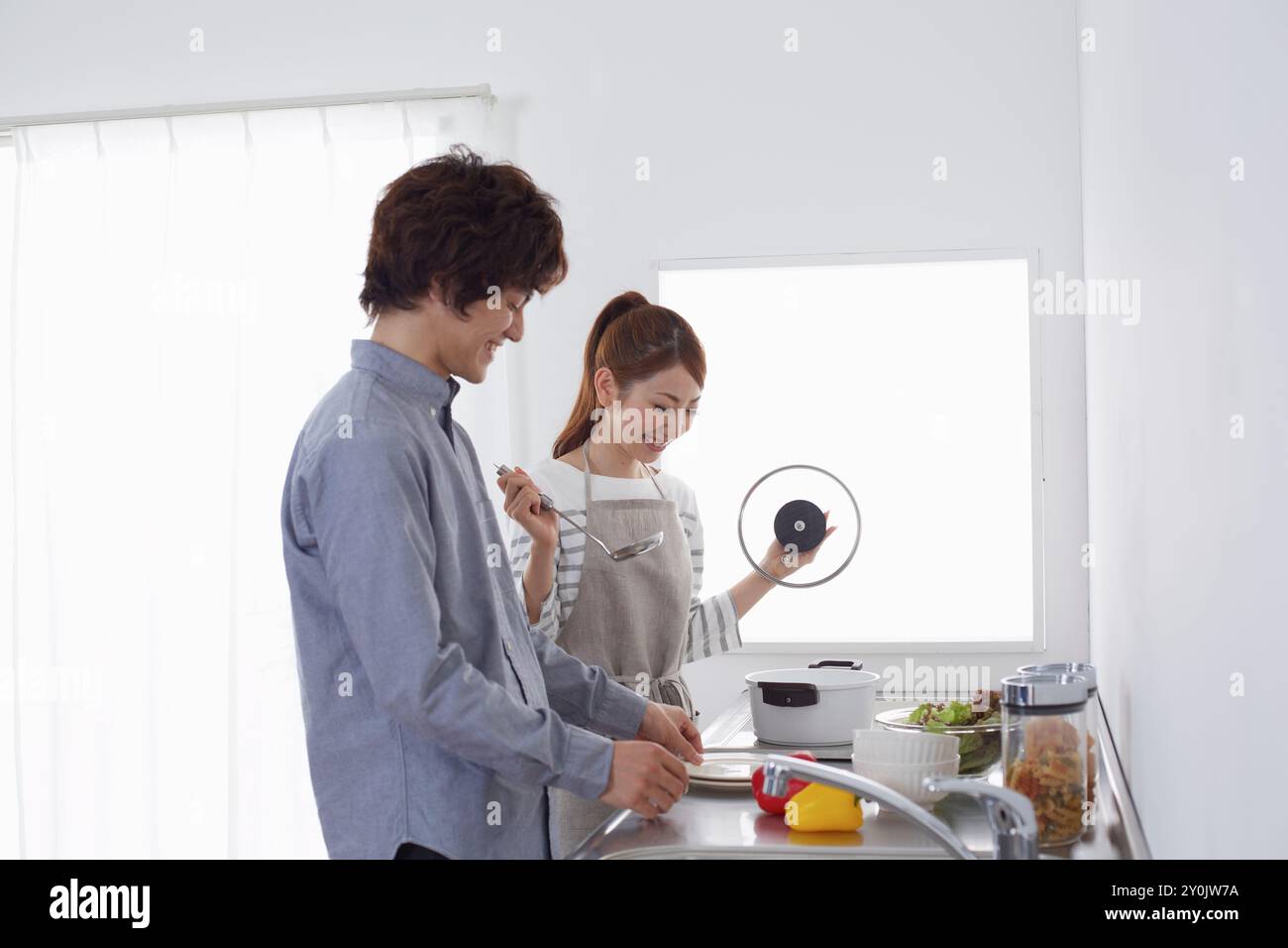 Husband and wife cooking in the kitchen Stock Photo - Alamy