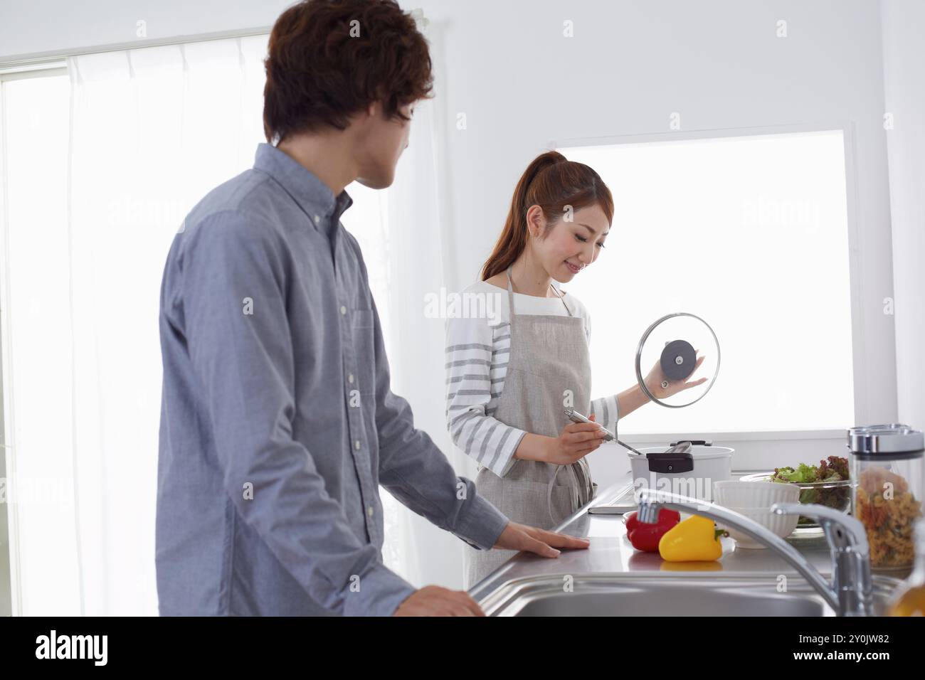Husband and wife cooking in the kitchen Stock Photo - Alamy