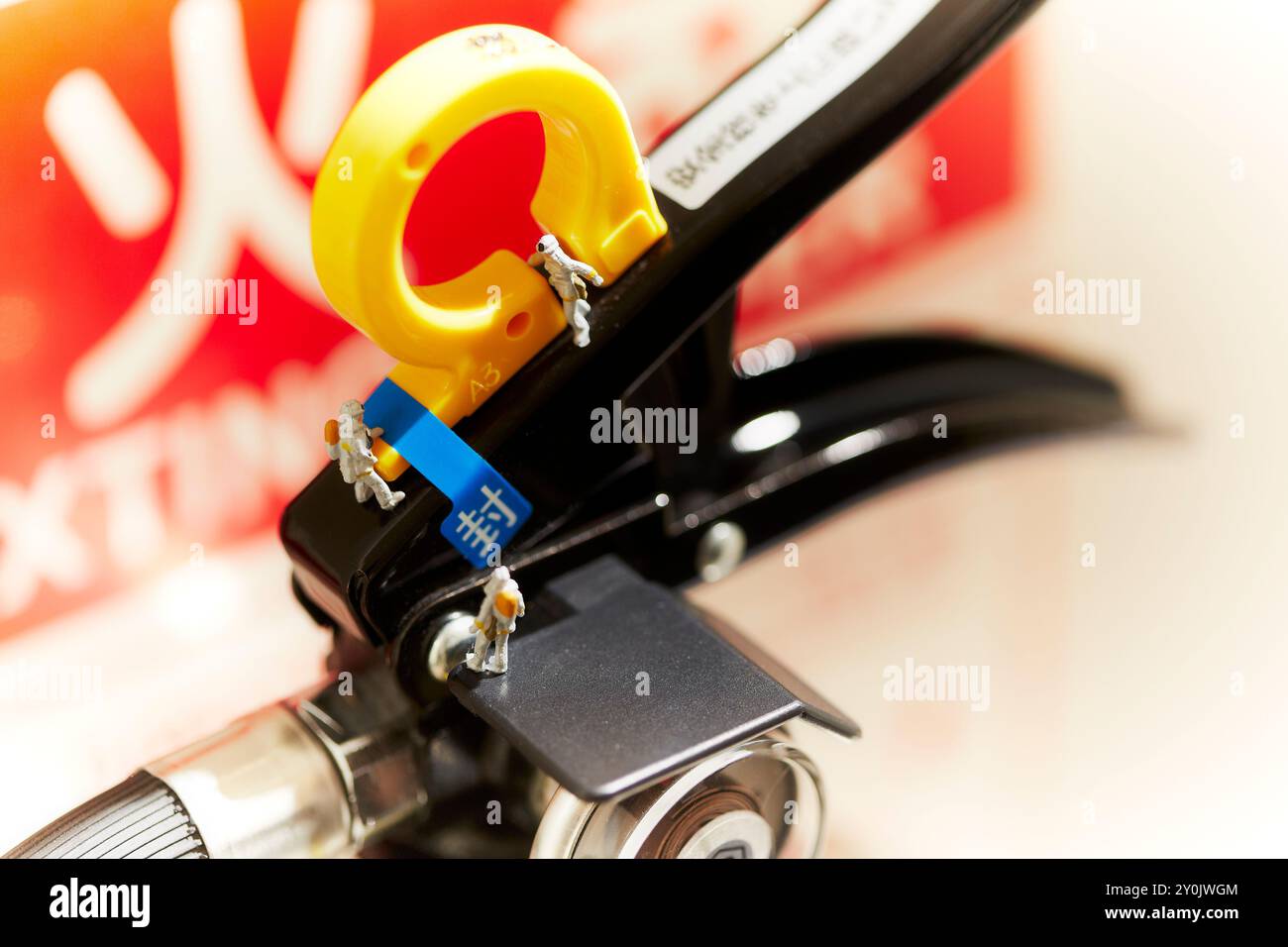 Three firefighter figures getting on fire extinguisher Stock Photo - Alamy