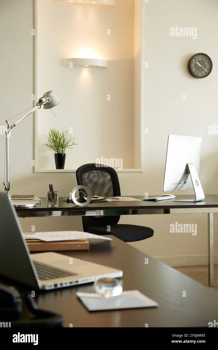 Two desks and documents and personal computer on the bookshelf desk in ...