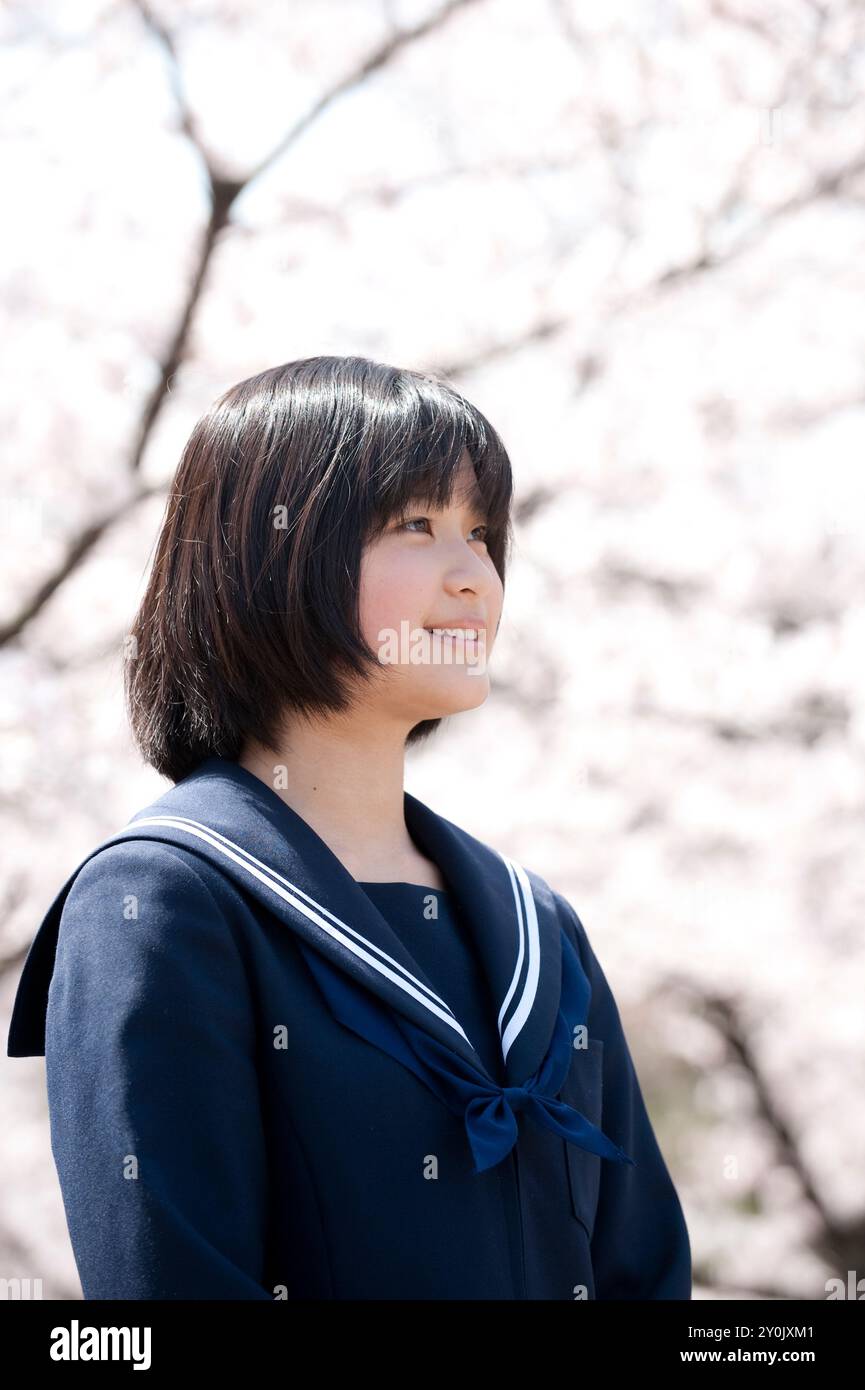 Junior high school girl and cherry blossom Stock Photo - Alamy