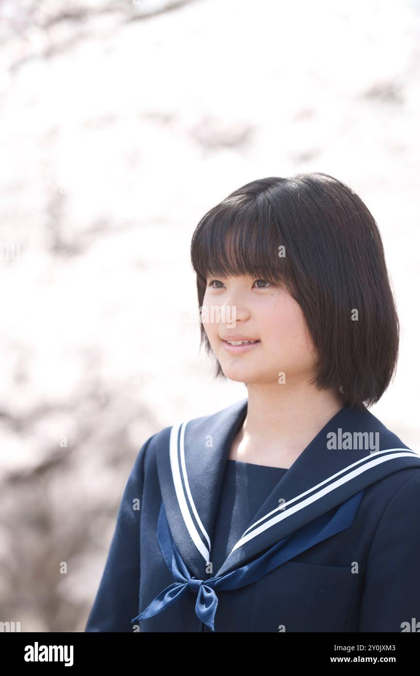 Junior high school girl and cherry blossom Stock Photo - Alamy