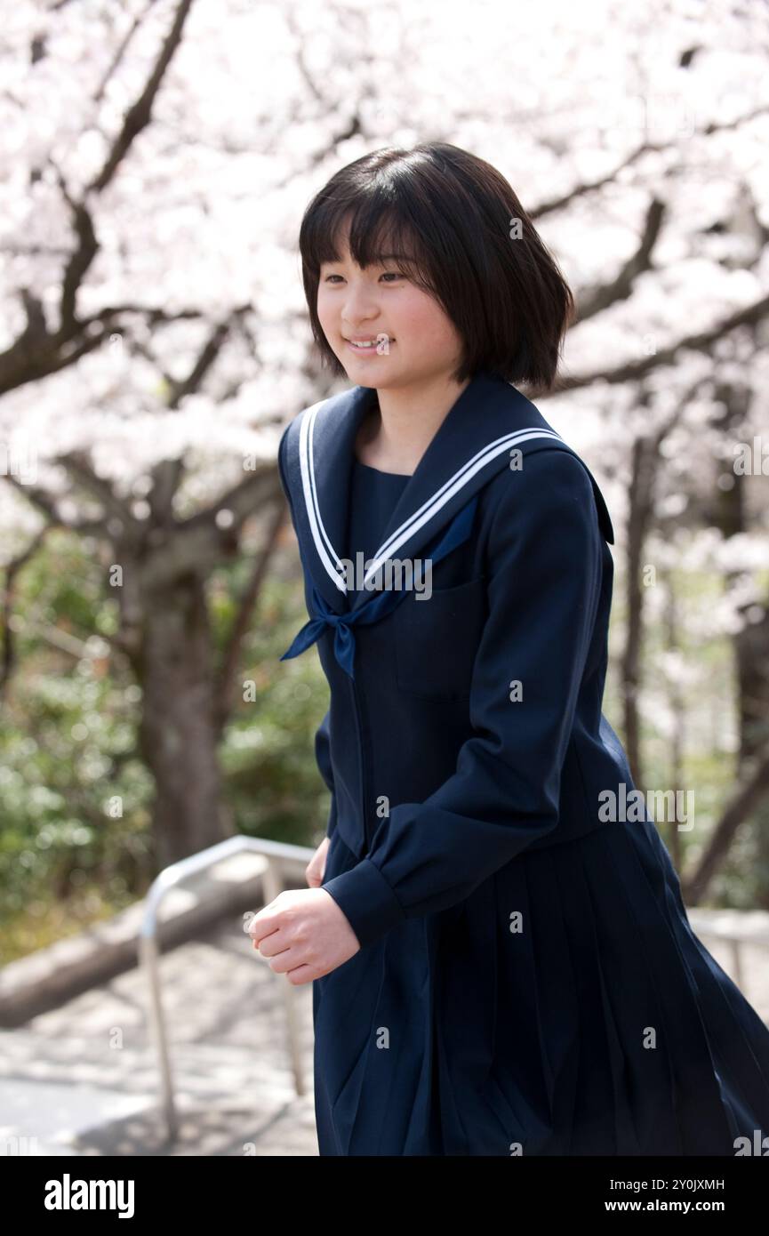 Junior high school girl and cherry blossom Stock Photo - Alamy