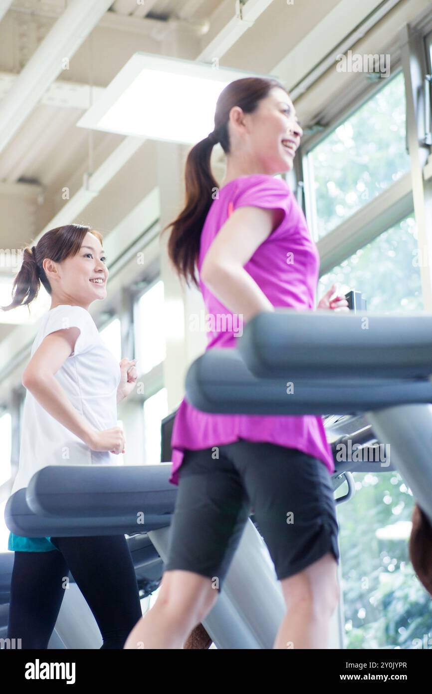 Two women exercising in a gym Stock Photo - Alamy
