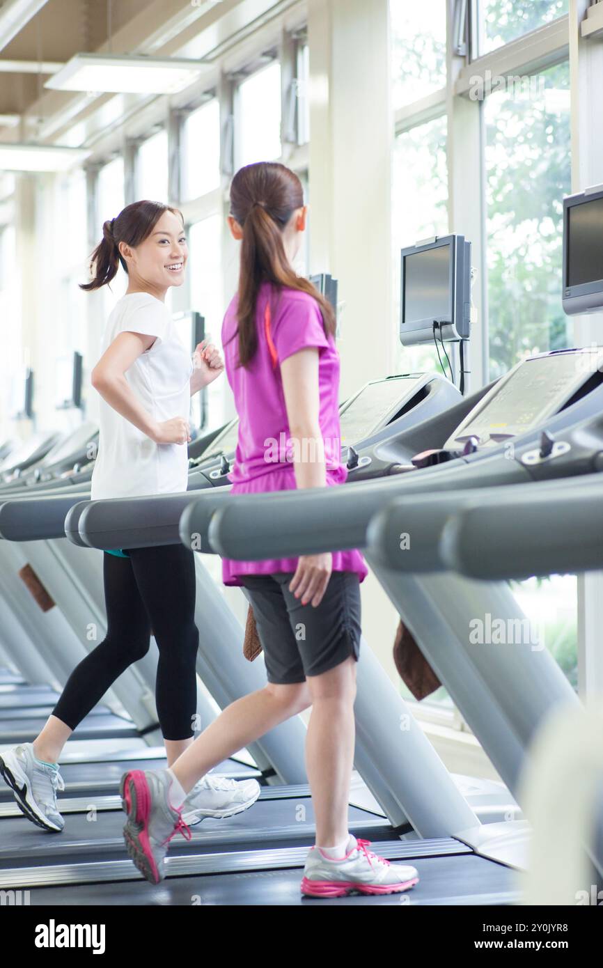 Two women exercising in a gym Stock Photo - Alamy