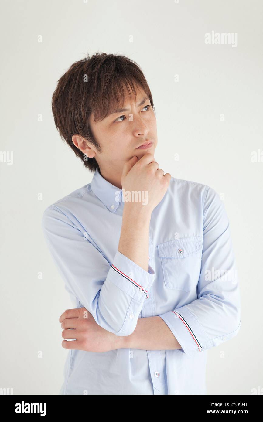 Thinking Japanese man Stock Photo - Alamy