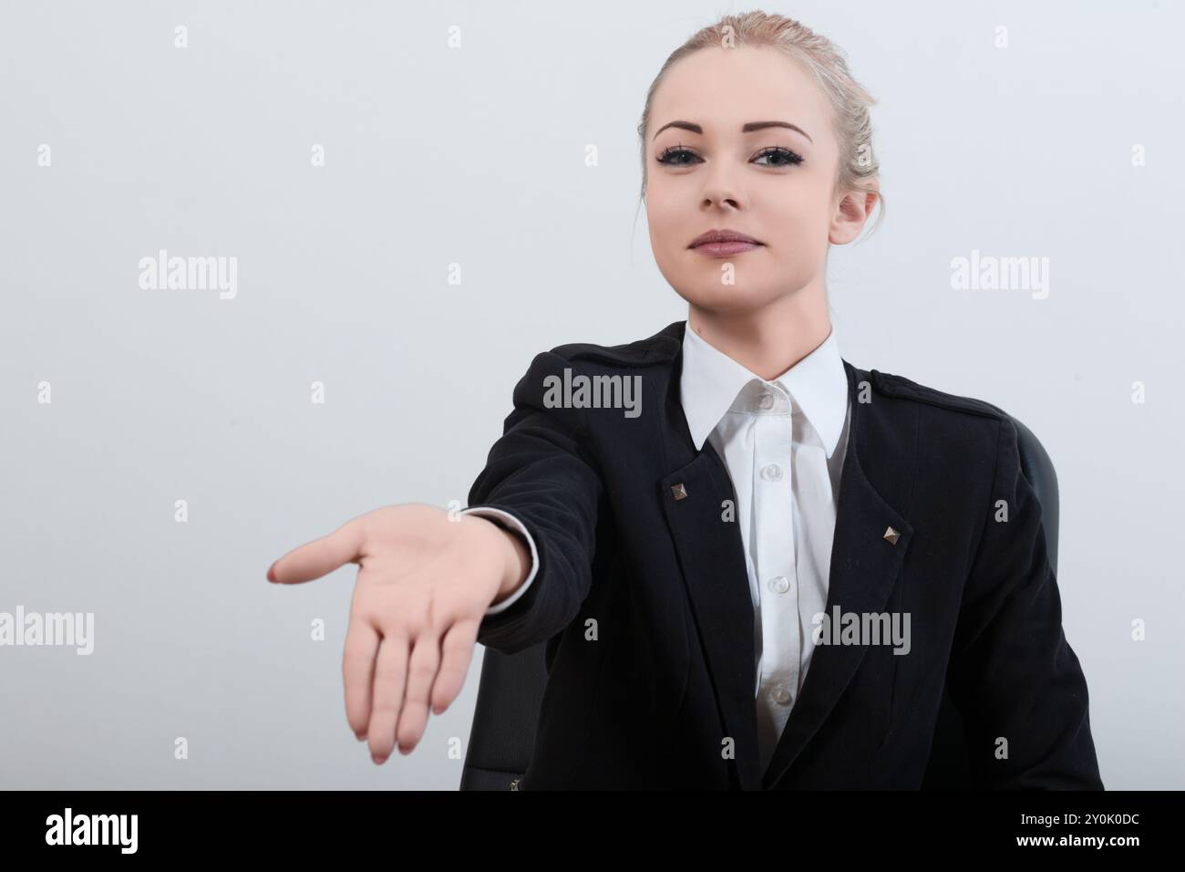 professional female officer in a black uniform extends her hand with a ...