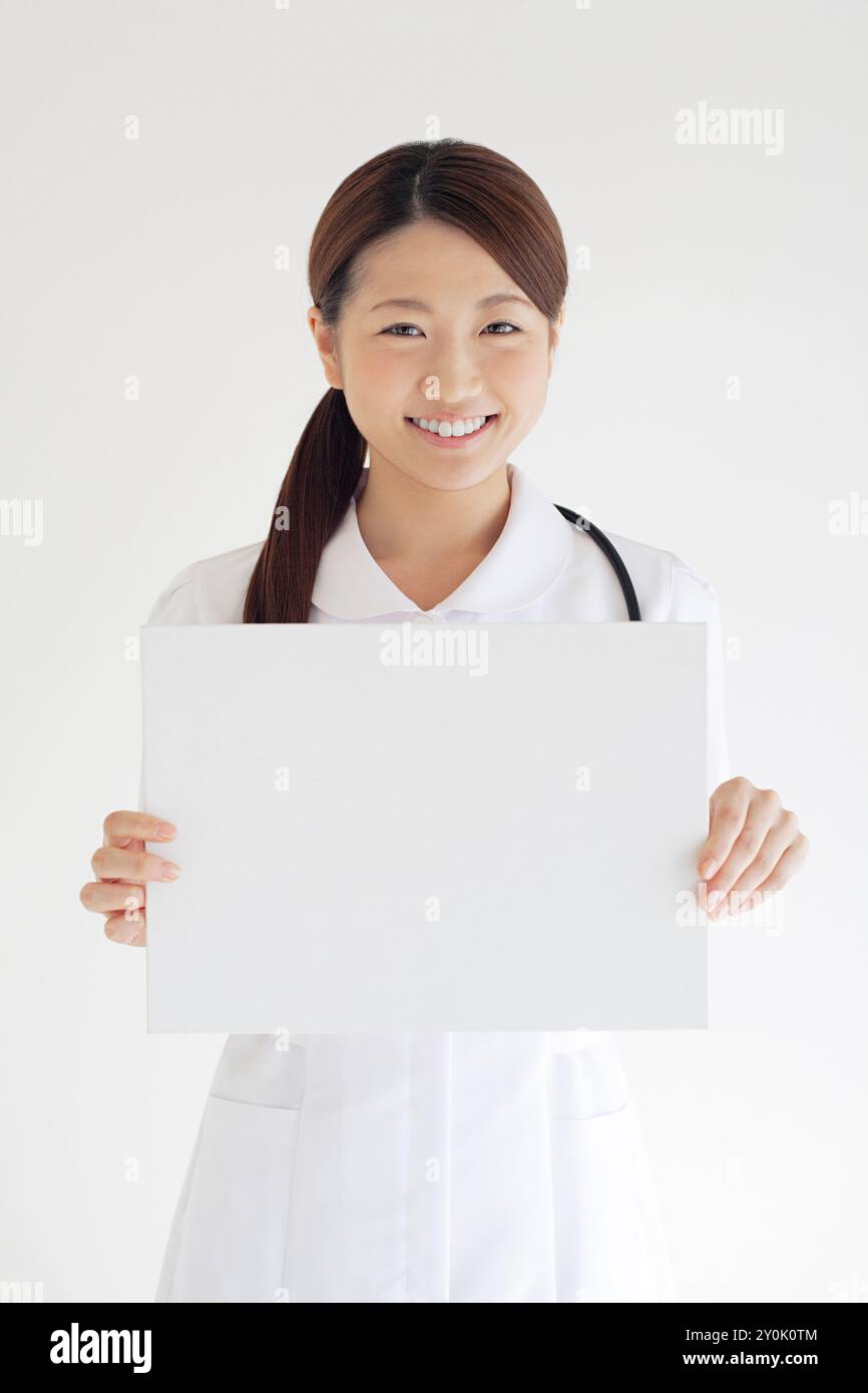 Nurse smiling with a message board Stock Photo - Alamy