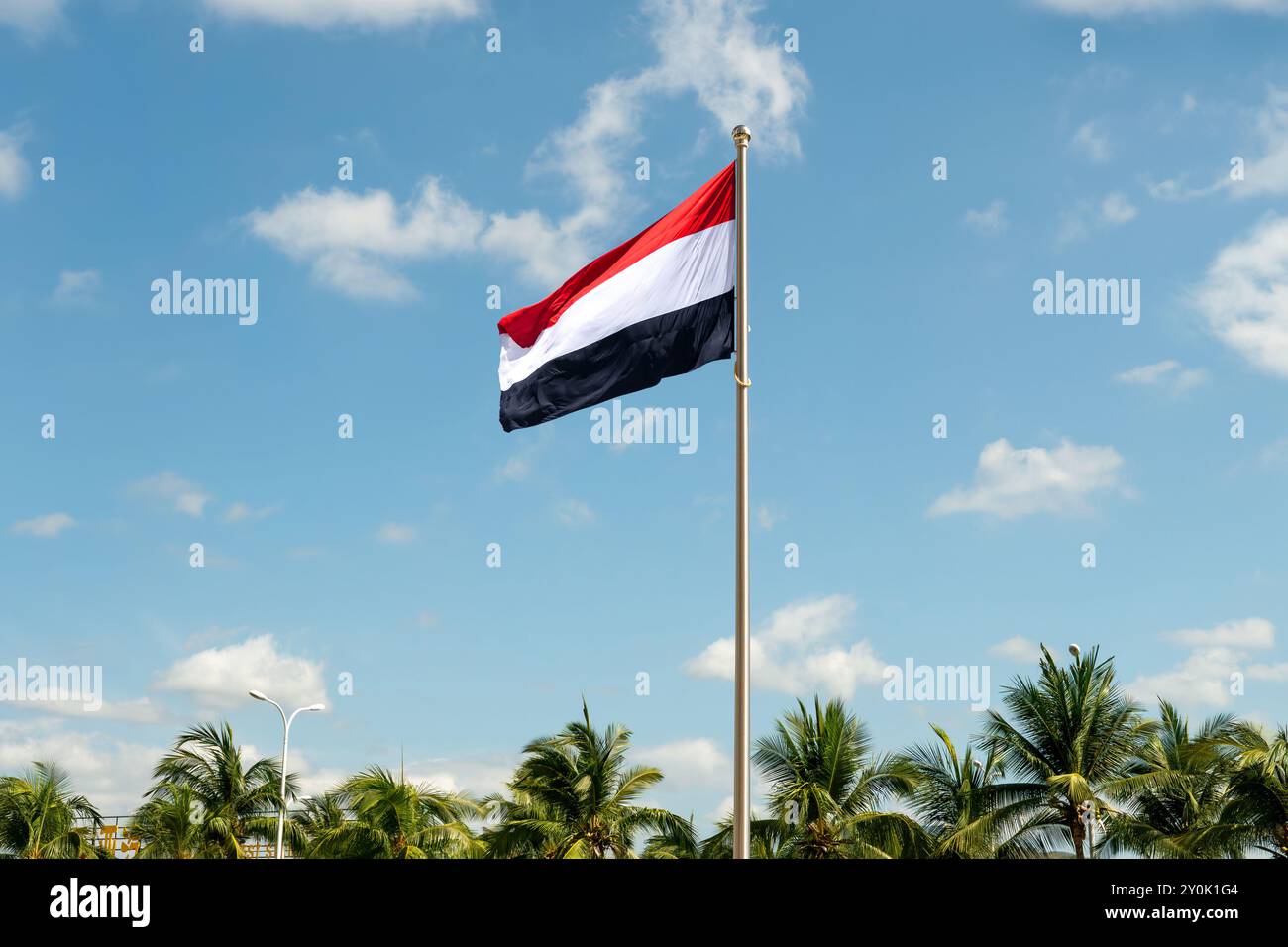 Yemen national flag waving in beautiful sky Stock Photo - Alamy