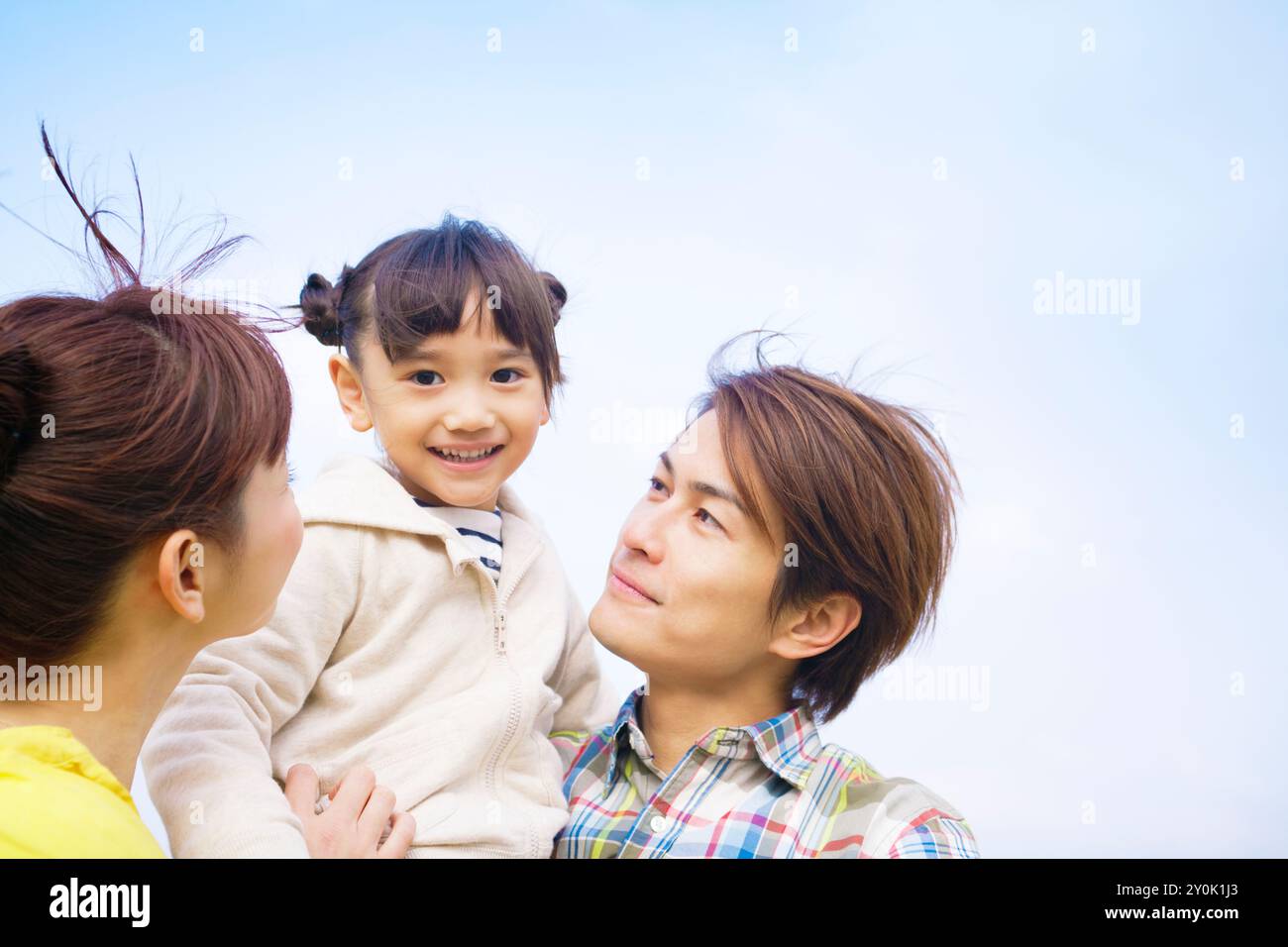Japanese family snuggling up to each other Stock Photo - Alamy