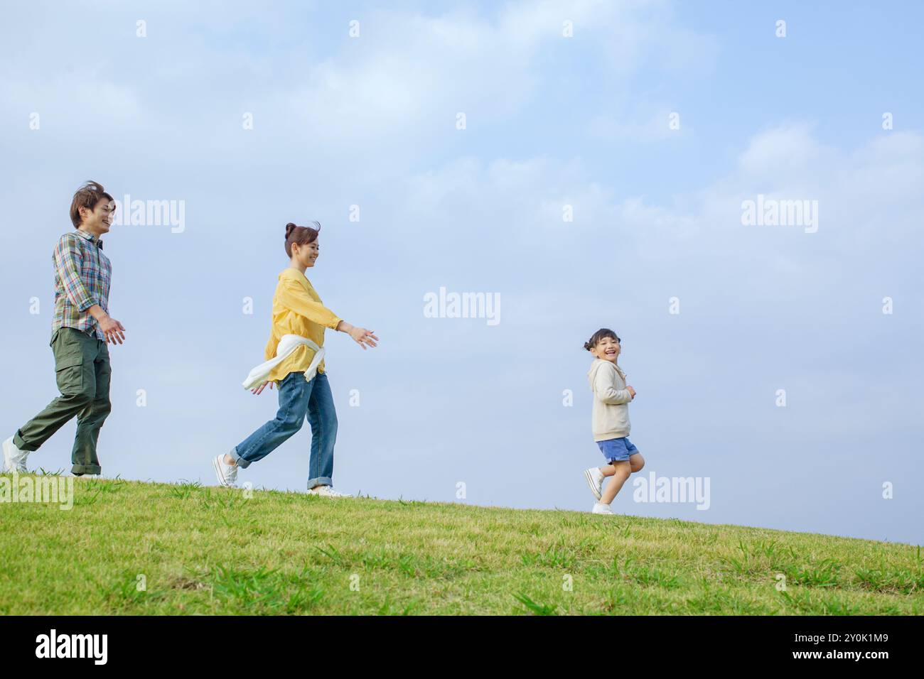 Smiling family walking on the hill Stock Photo - Alamy