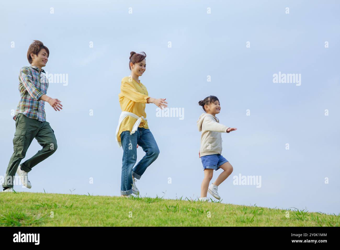 Smiling family walking on the hill Stock Photo - Alamy