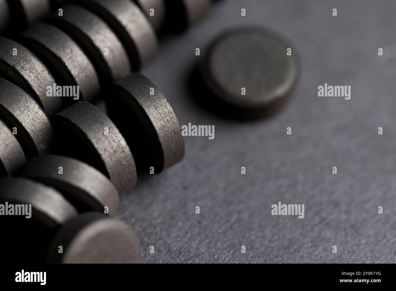 Open and unpacked tablets of black color close-up, a large number of ...