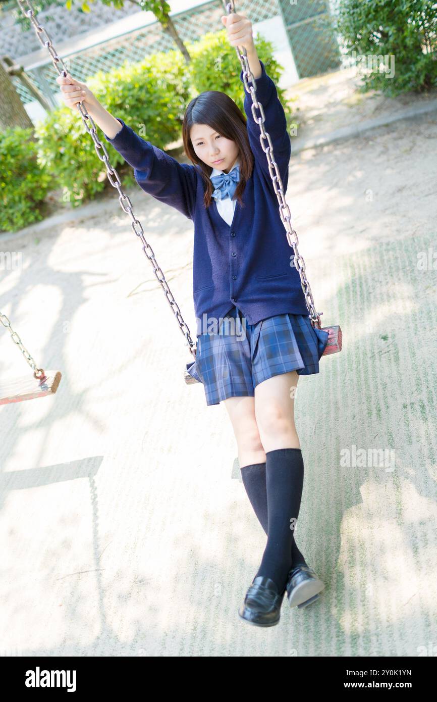 Japanese high school girl enjoying a swing ride Stock Photo - Alamy