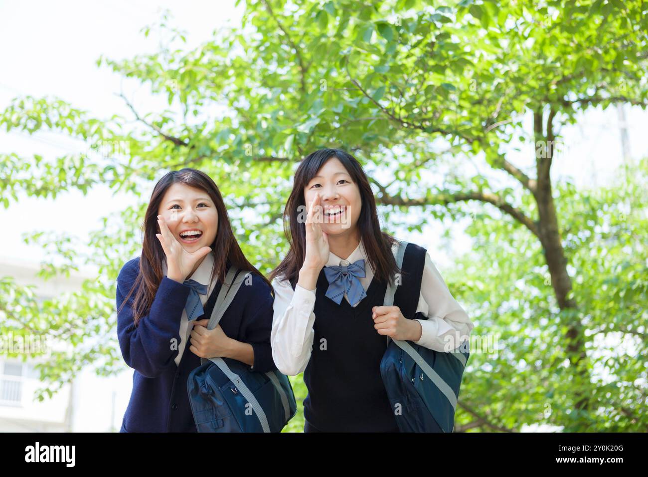 Two Japanese highschool girls calling out Stock Photo - Alamy