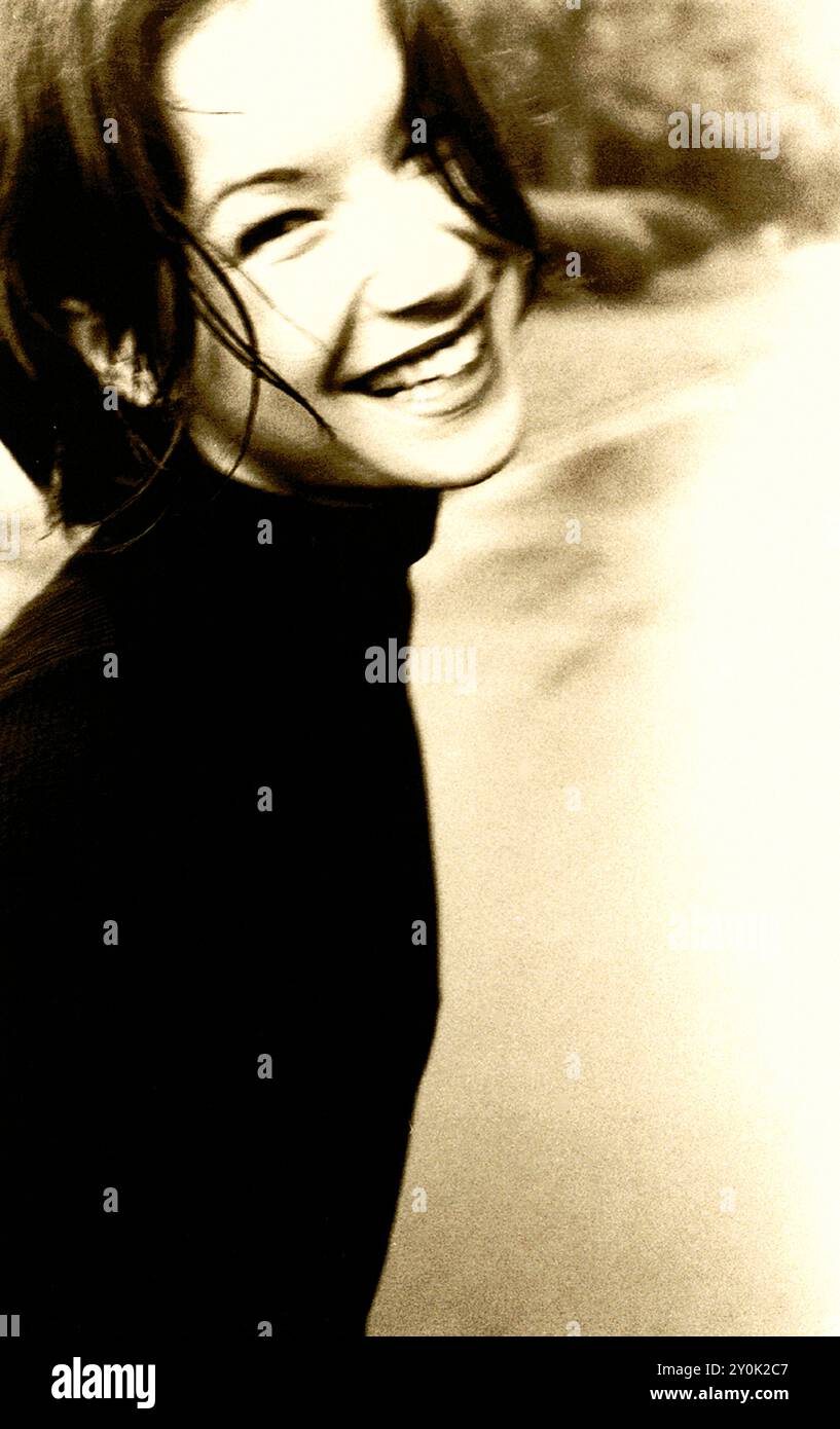 Women looking back with a smile Stock Photo - Alamy