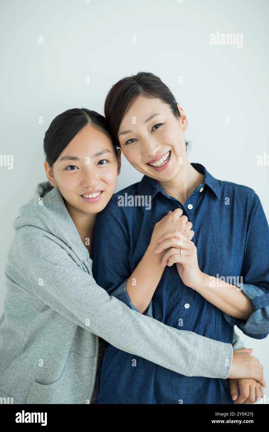 Mother and daughter snuggling up with smiles Stock Photo - Alamy