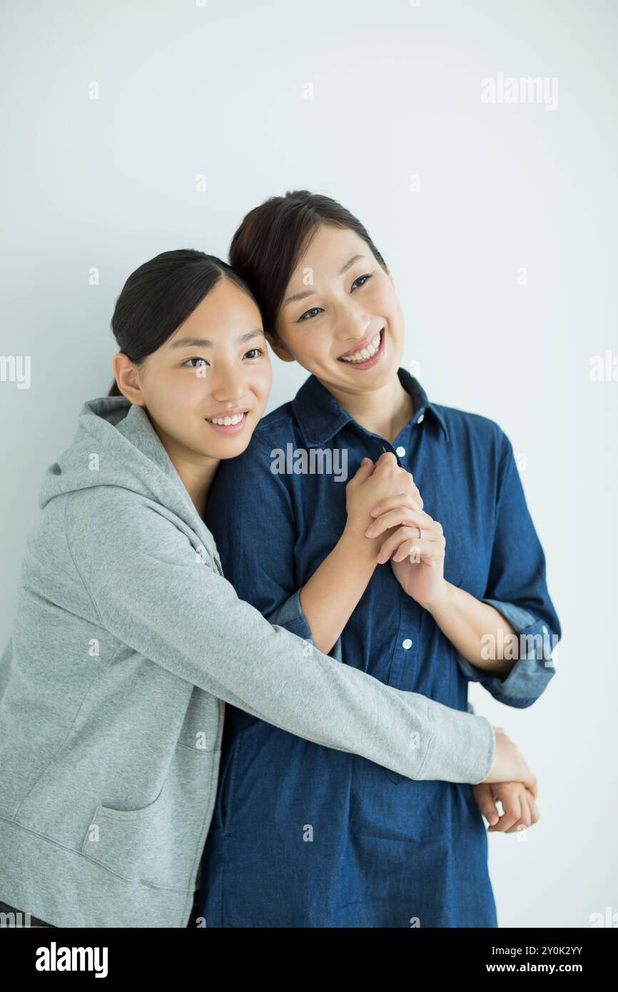 Mother and daughter snuggling up with smiles Stock Photo - Alamy