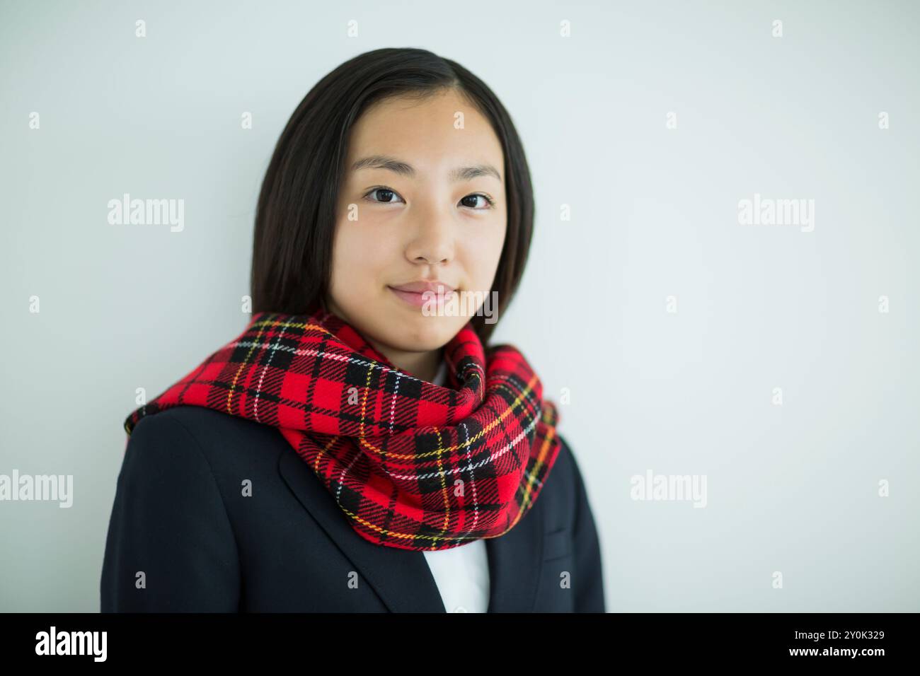 High school girl with scarf wrapped around her Stock Photo - Alamy