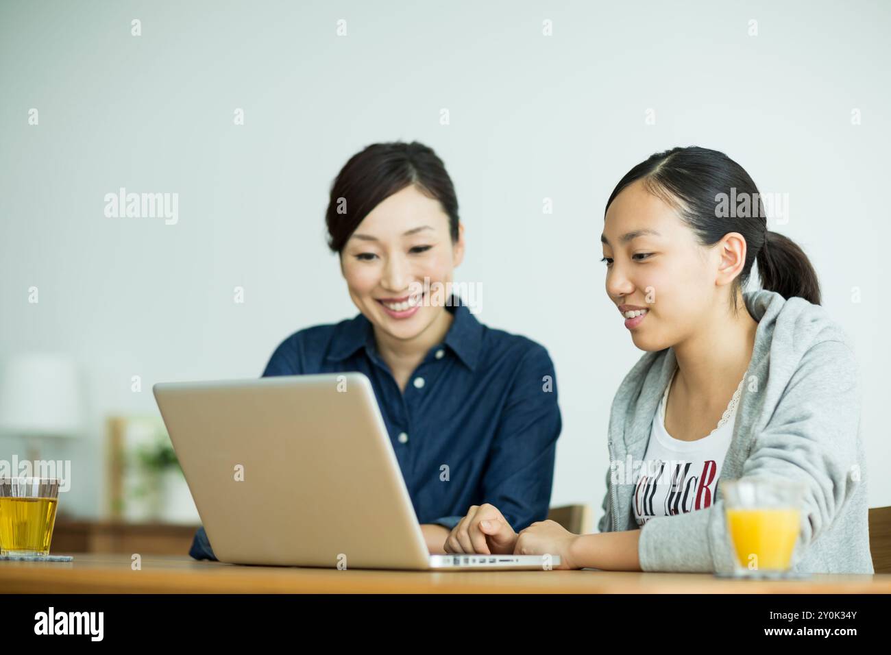 Mother and daughter using personal computer Stock Photo - Alamy
