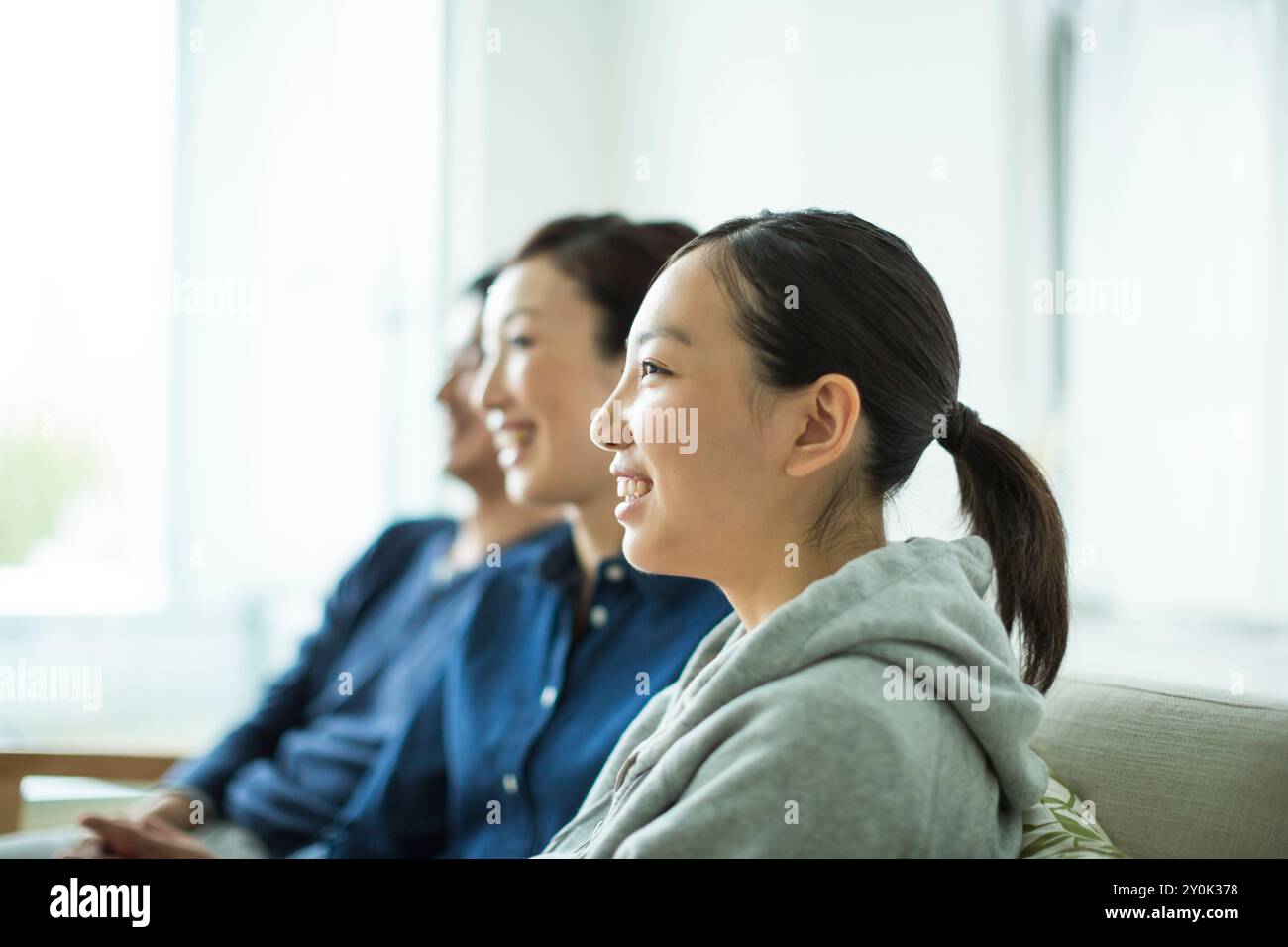 Three people family smiling Stock Photo - Alamy