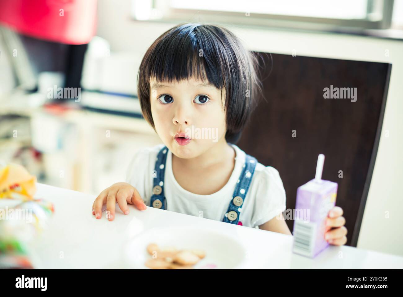 Girl sitting on the table Stock Photo - Alamy
