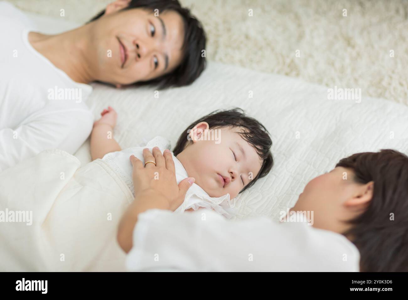 Parents watching a sleeping baby Stock Photo - Alamy