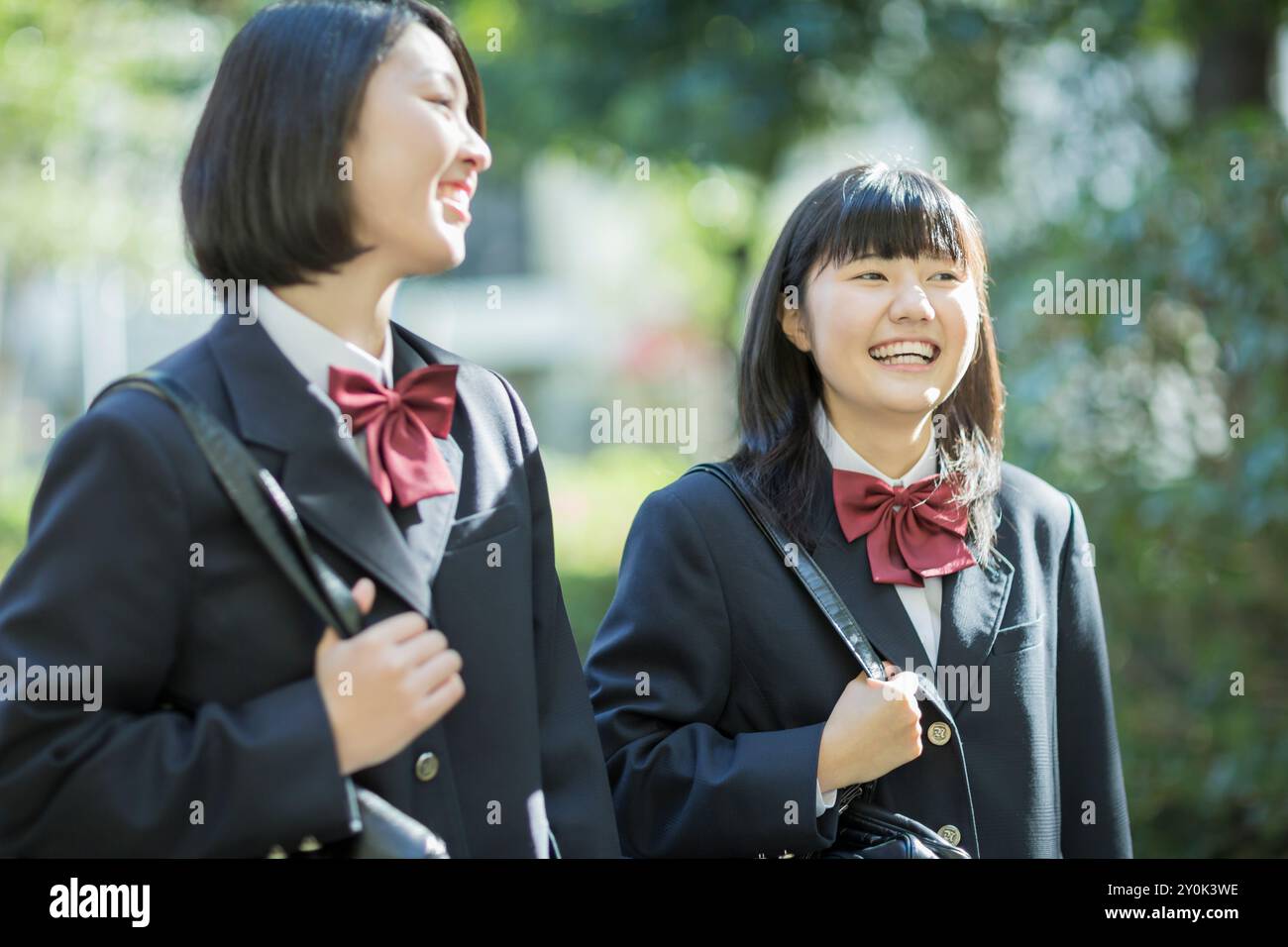 High school girls going to school with a smile Stock Photo - Alamy
