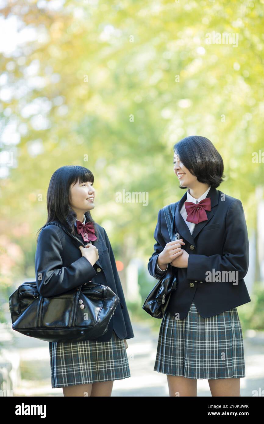 High school girls having a conversation with a smile Stock Photo - Alamy