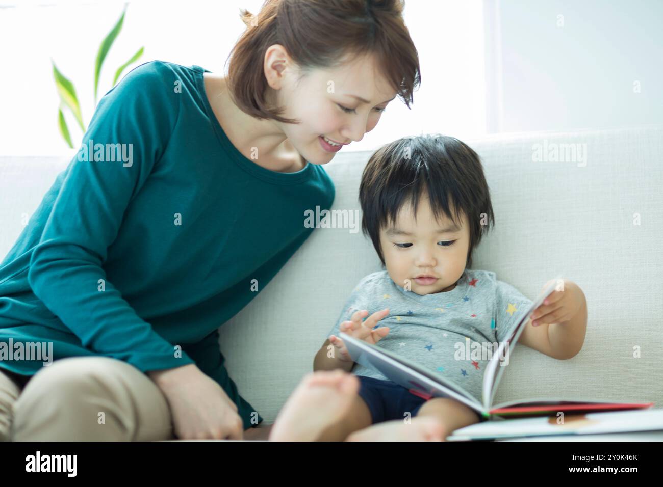 Child on book hi-res stock photography and images - Alamy