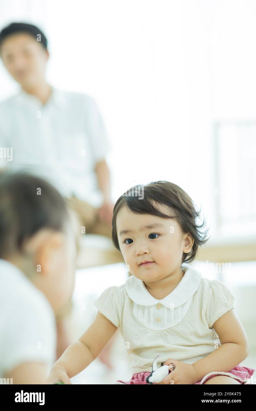 Two babies facing each other Stock Photo - Alamy