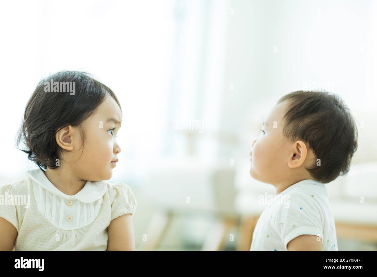 Two babies facing each other Stock Photo - Alamy