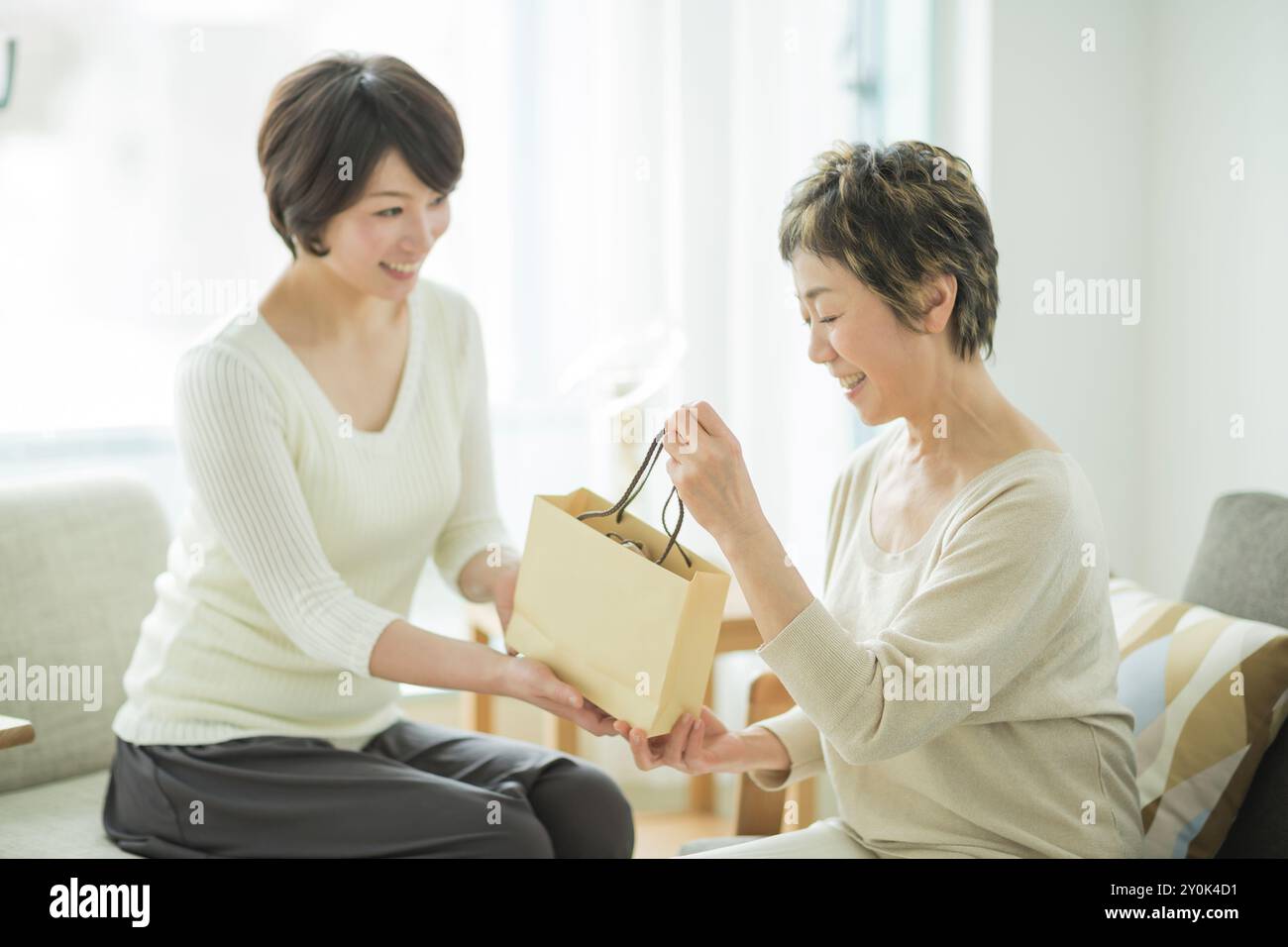 Mother receiving gifts from her daughter Stock Photo - Alamy