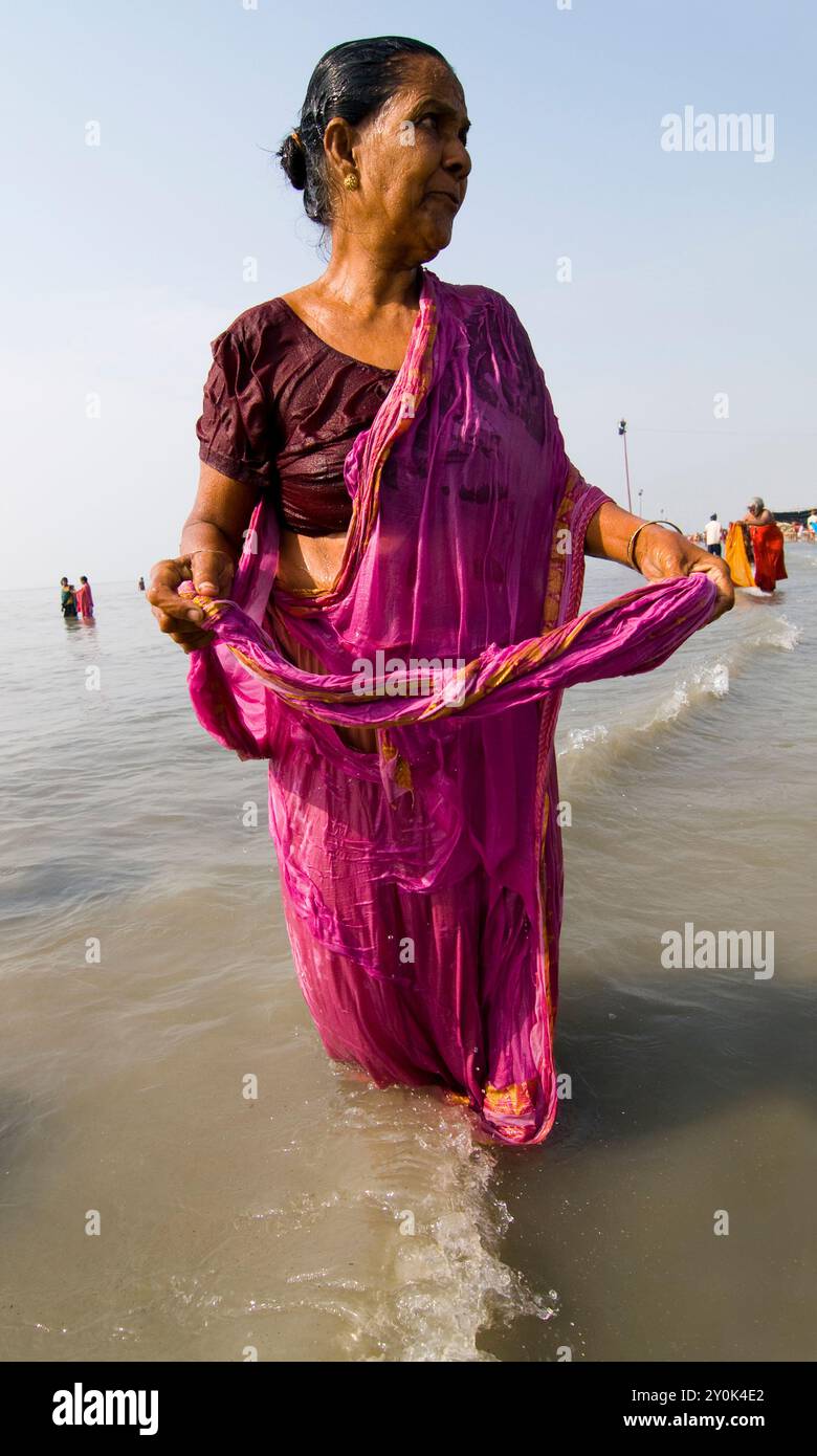 Indian women perform a puja by the holy Ganga water at Gangasagar, West ...