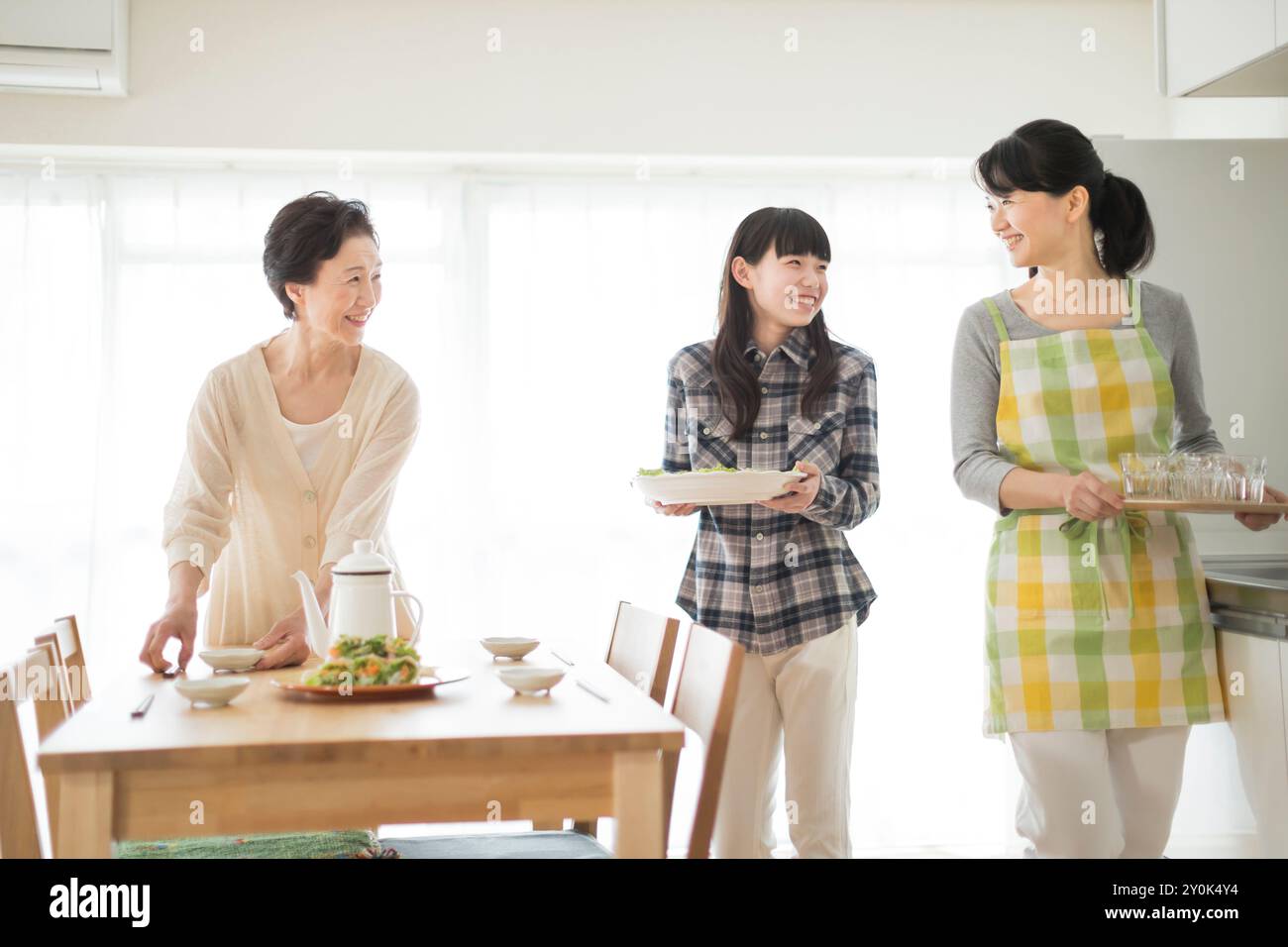 Three generations of a family preparing food Stock Photo - Alamy