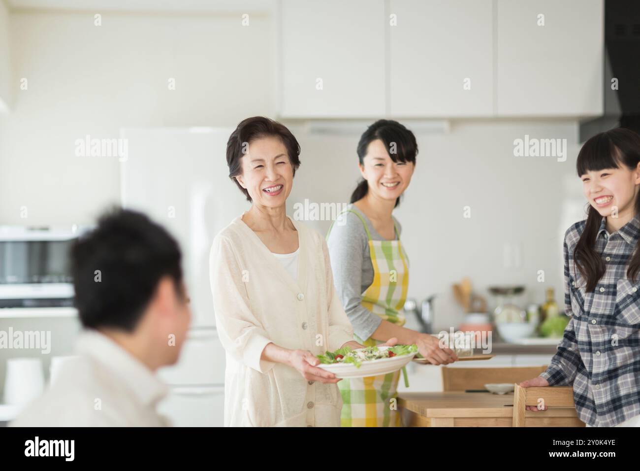 Three generations of a family preparing food Stock Photo - Alamy