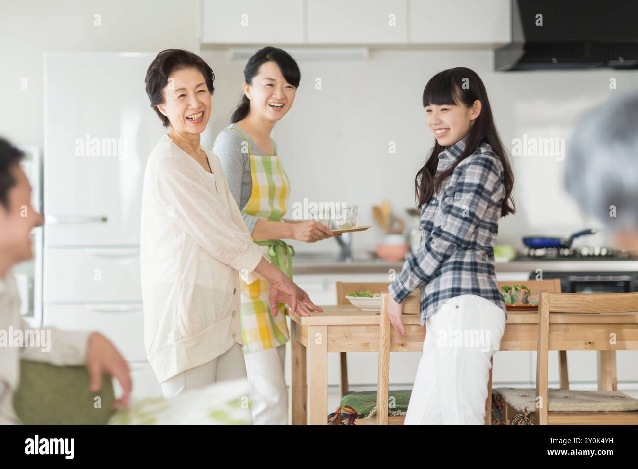 Three generations of a family preparing food Stock Photo - Alamy