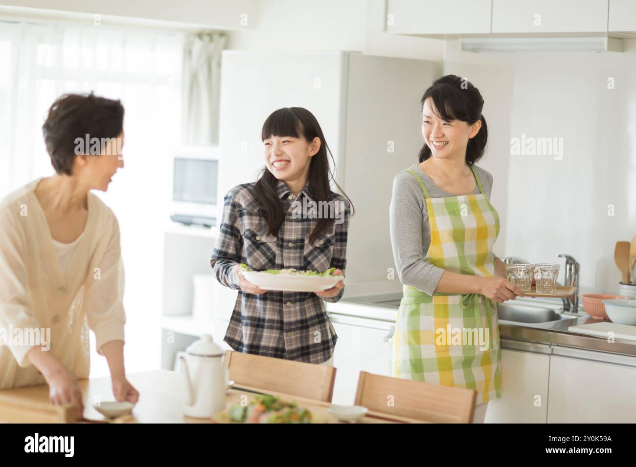 Three generations of a family preparing food Stock Photo - Alamy